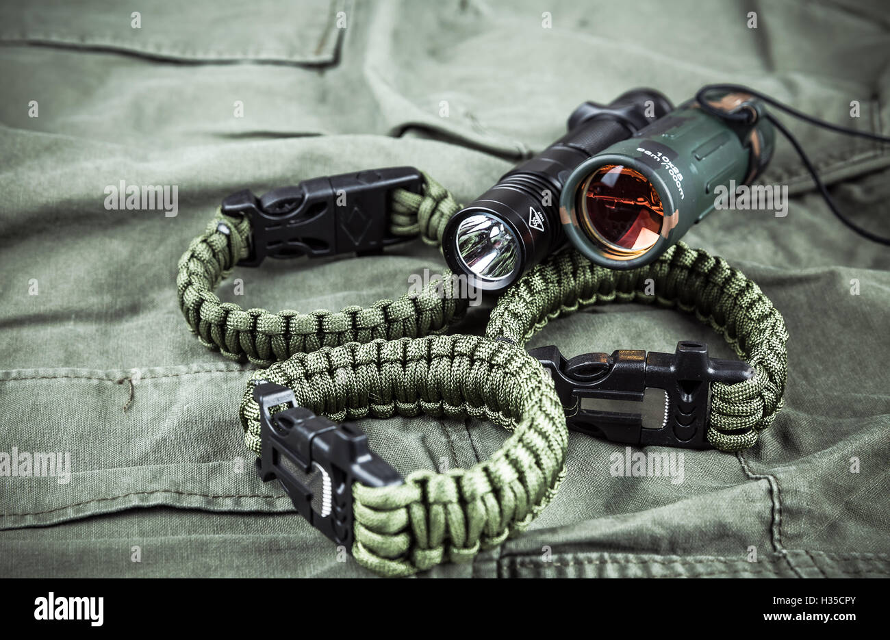 Military paracord bracelet, tactical torch and spy-glass Stock Photo ...
