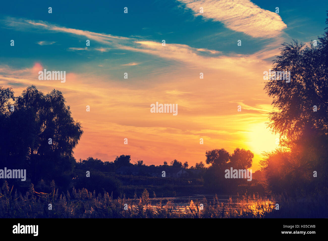 Rural landscape with lake at sunset Stock Photo - Alamy