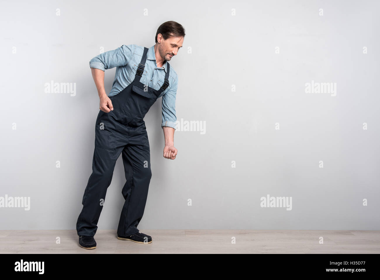 Concentrated man imitating digging Stock Photo - Alamy
