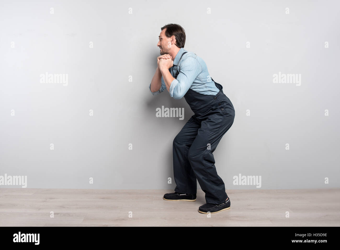 Good looking middle aged man standing in profile Stock Photo - Alamy