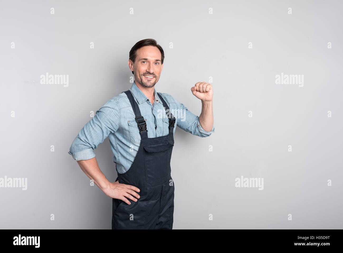 Handsome strong man showing his strength Stock Photo - Alamy