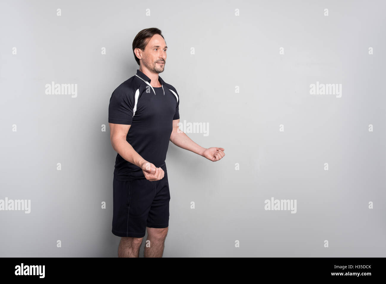 Pleasant man springing on the jump rope Stock Photo - Alamy