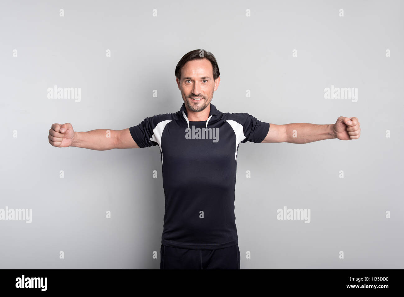 Positive man doing physical exercises Stock Photo - Alamy