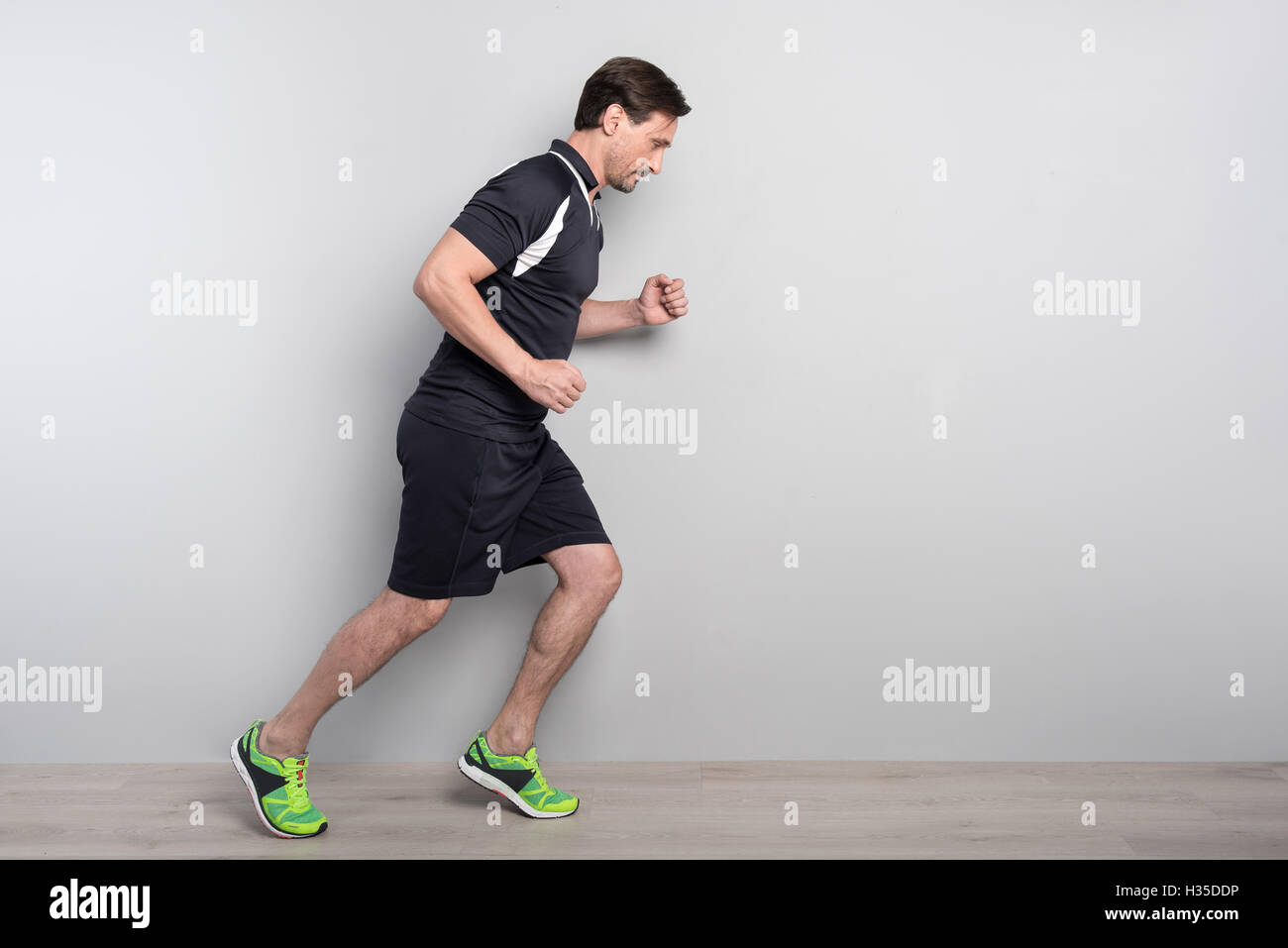 Concentrated man running Stock Photo - Alamy
