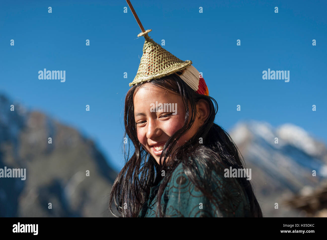 A Layap girl wearing a traditional hat smiles for the camera in the ...