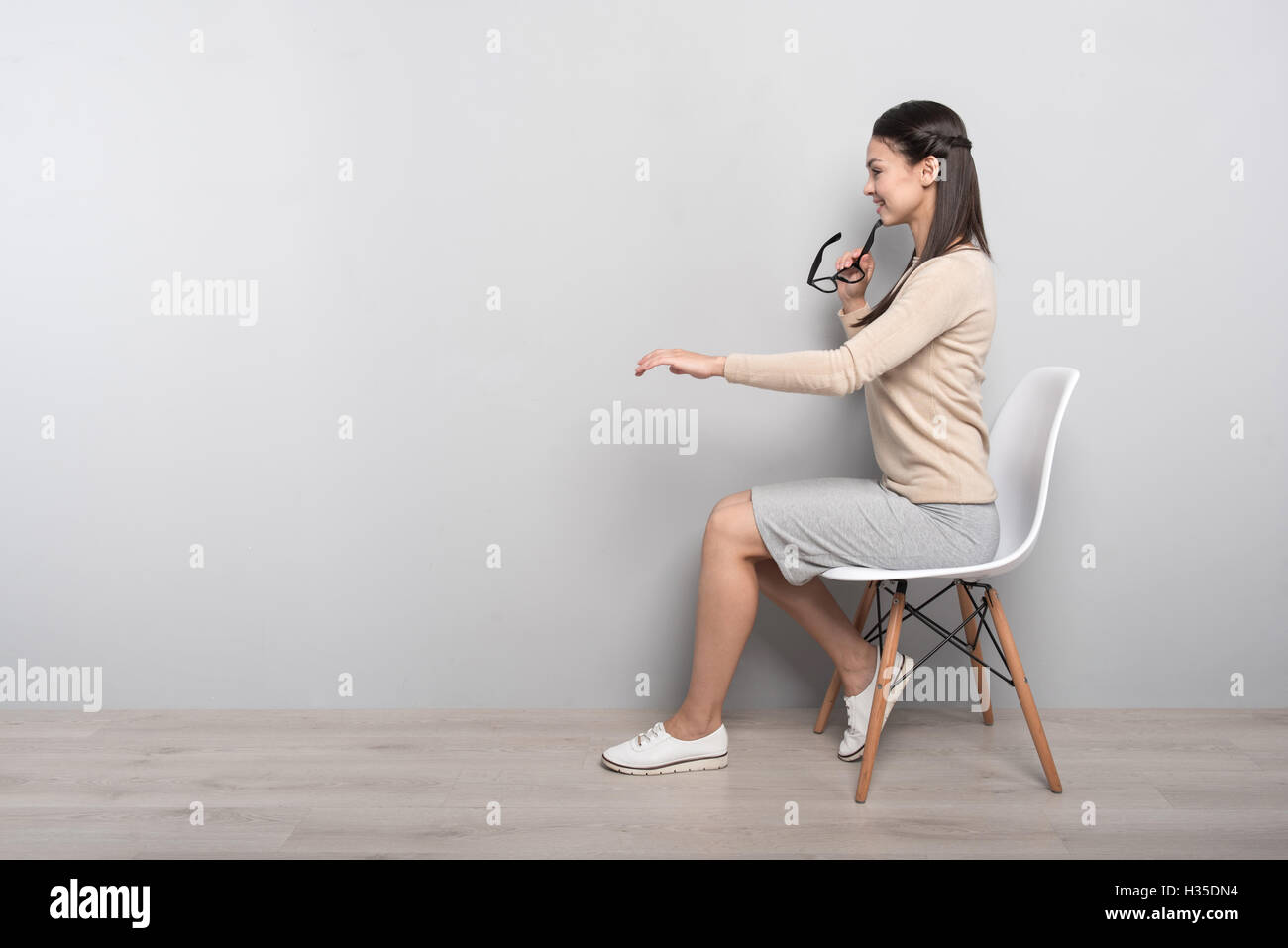 Positive woman sitting in the chair Stock Photo - Alamy