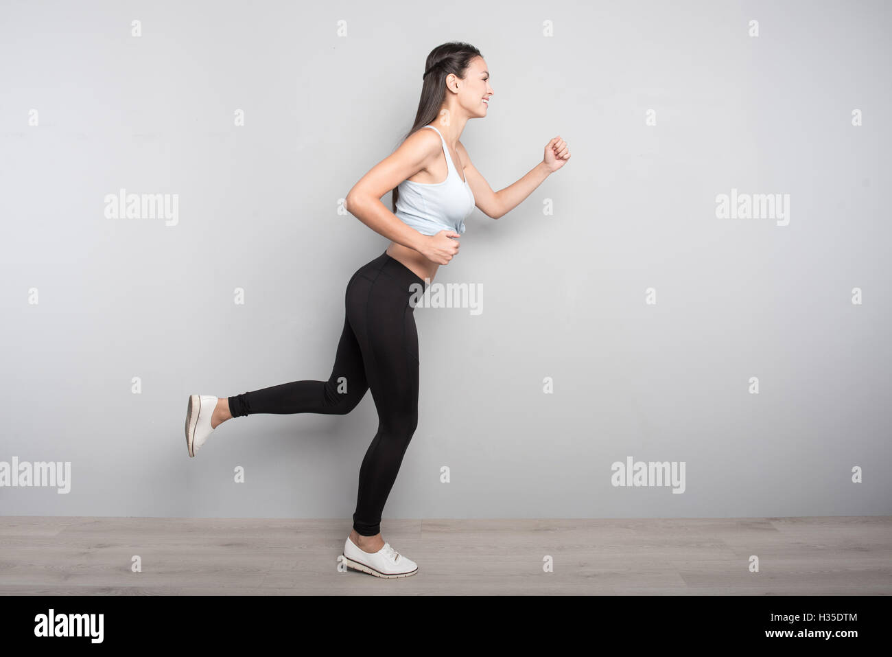 Positive slim woman running Stock Photo - Alamy
