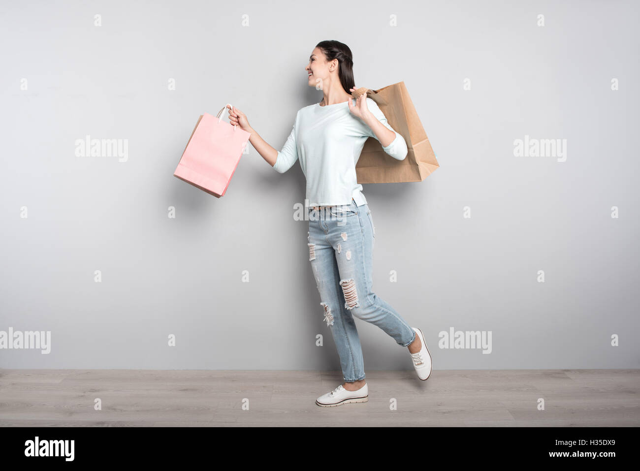 Positive woman holding packages Stock Photo - Alamy