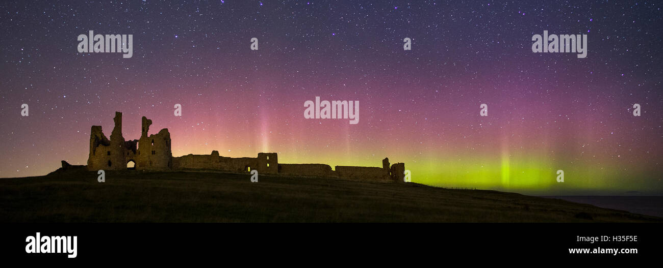 The Northern Lights at Dunstanburgh Castle, Northumberland Stock Photo ...