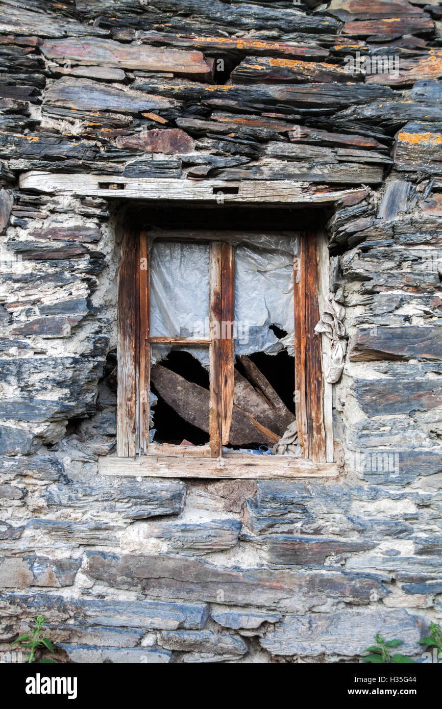 Color image of a broken window on a stone wall Stock Photo - Alamy