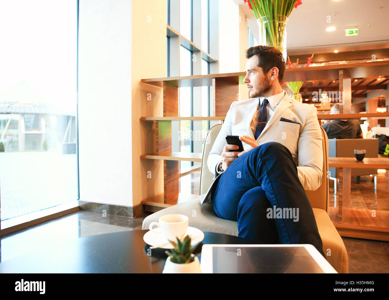 Portrait of handsome successful man drink coffee sitting in coffee shop ...