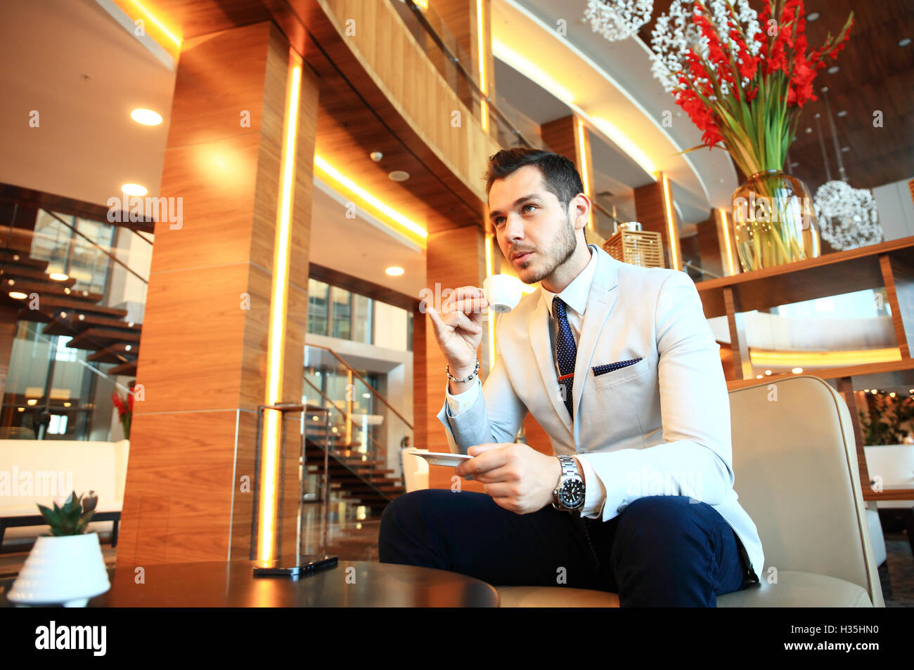 Portrait of handsome successful man drink coffee sitting in coffee shop ...