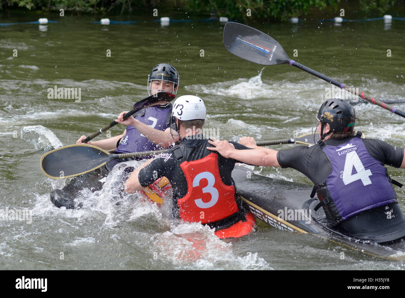 Participants in a canoe water polo match competing to win on the River ...