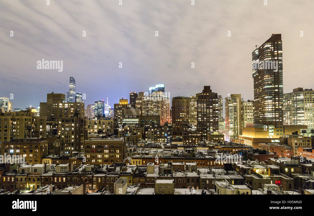 Snowy rooftops and mIdtown Manhattan at night, seen from 72nd street on ...