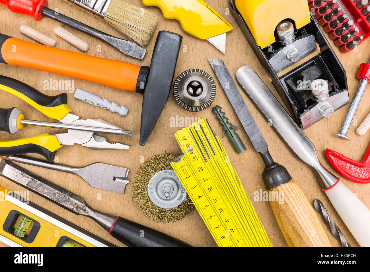 Set of assorted working tools on wooden background Stock Photo - Alamy