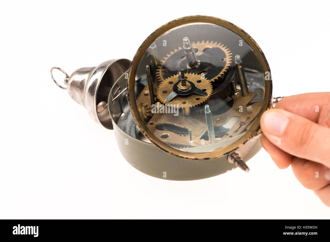 The male hand with magnifier and clockwork Stock Photo - Alamy