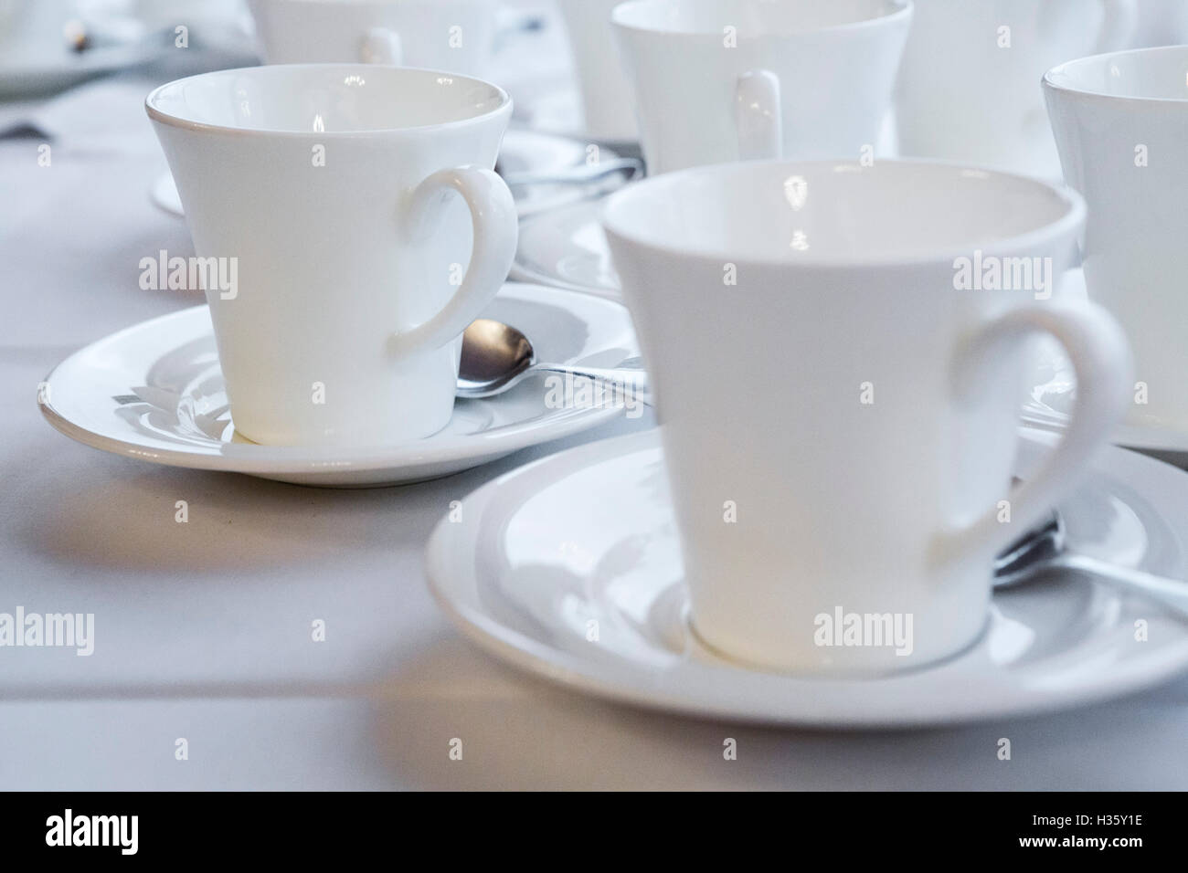 White cups on a table Stock Photo - Alamy