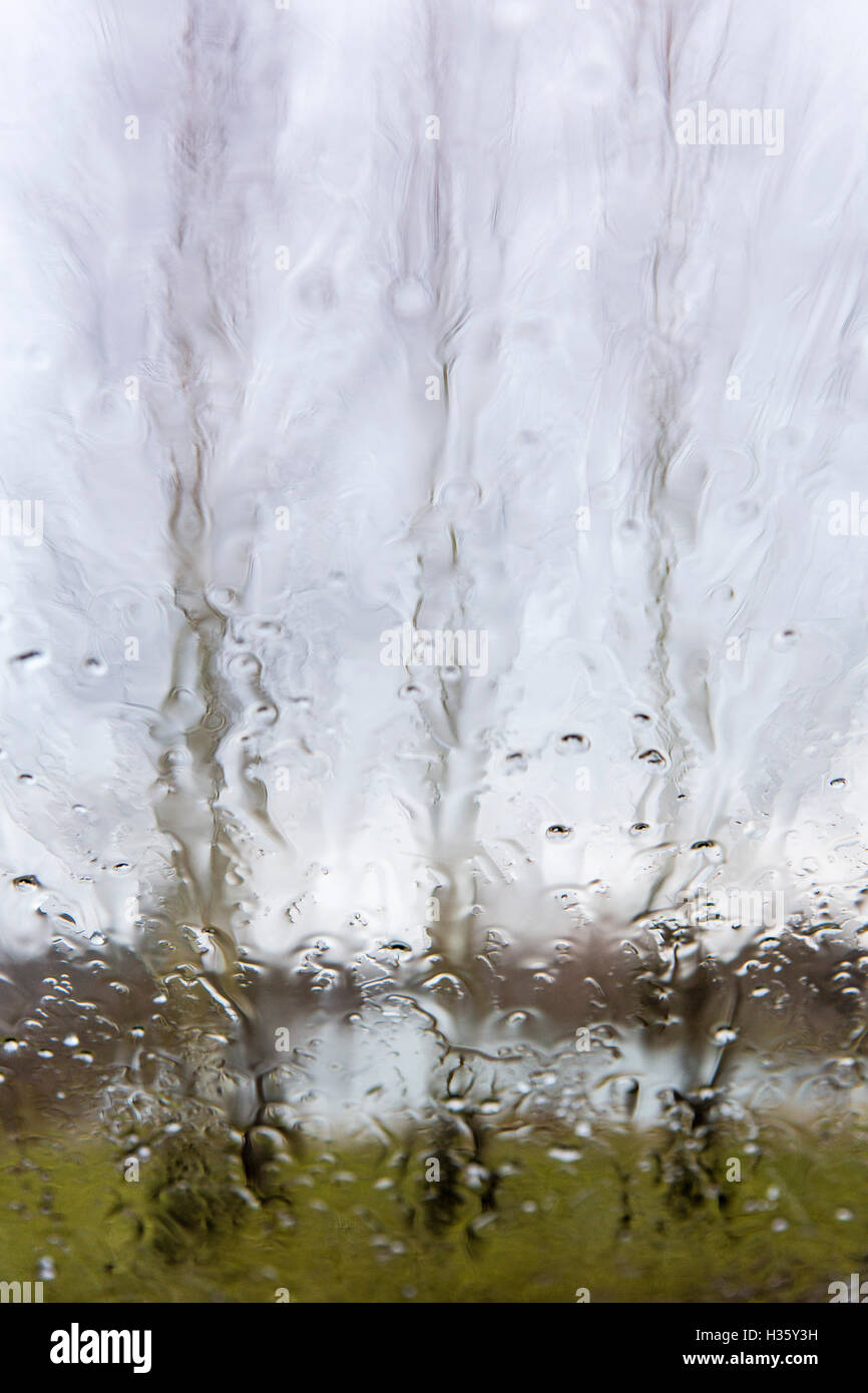 Trees seen through a rain splashed car window Stock Photo - Alamy