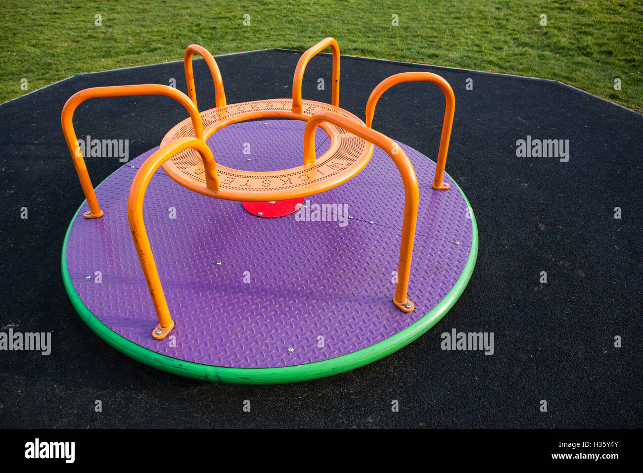 Colourful roundabout in a childs playground Stock Photo - Alamy