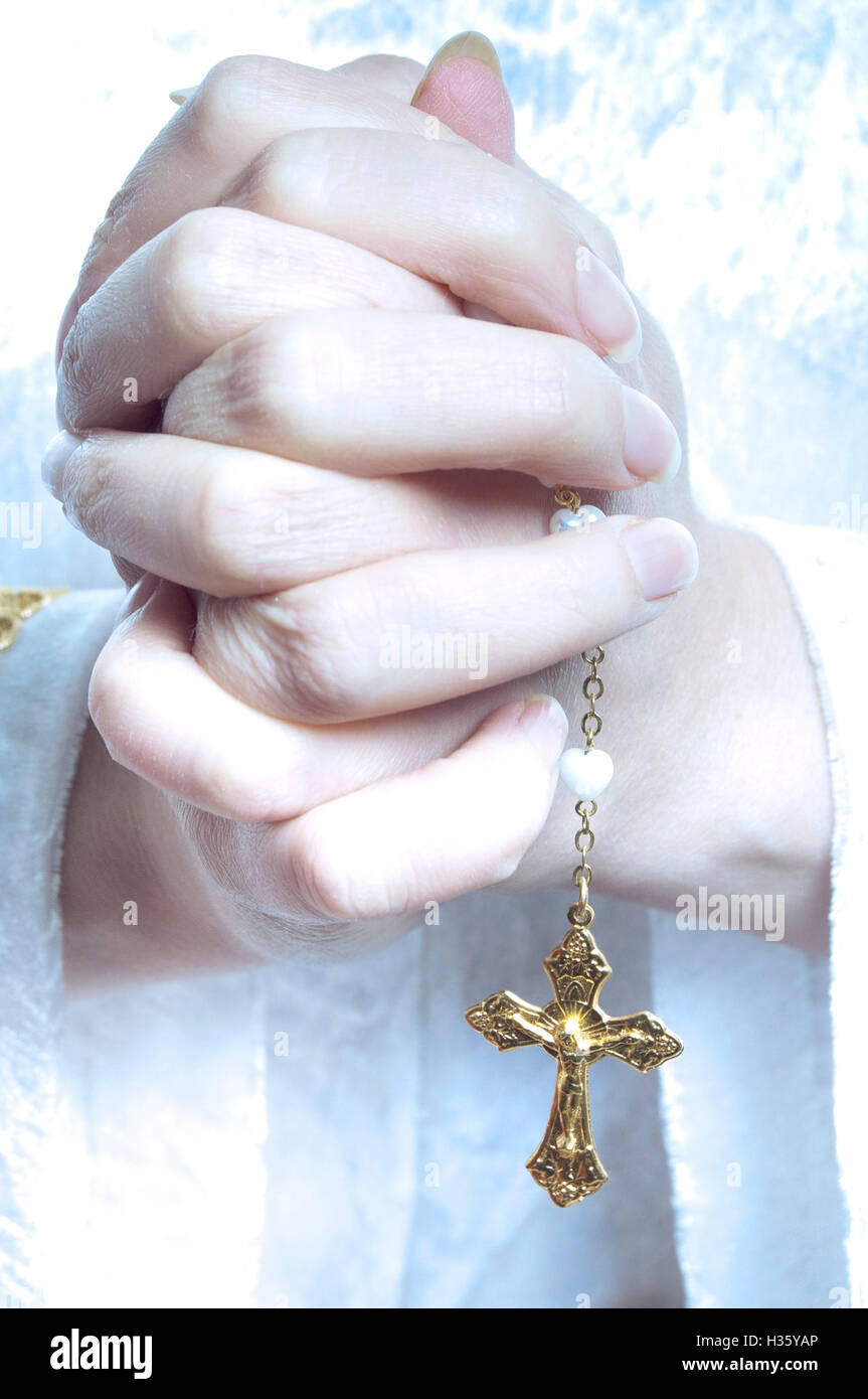 hands with rosary in prayer Stock Photo - Alamy