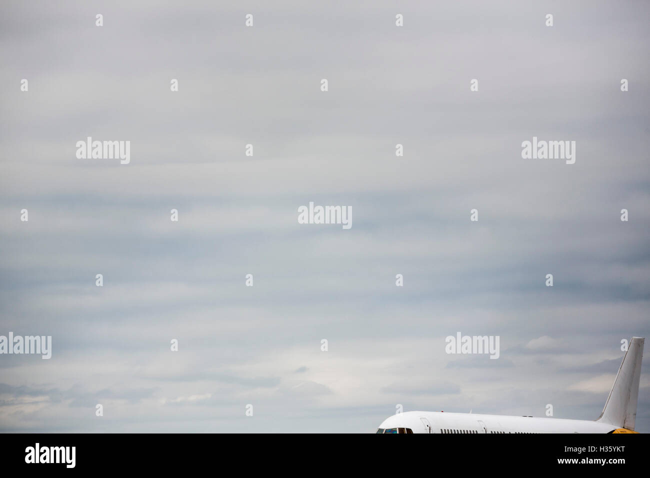 Jet airliner against a grey sky Stock Photo - Alamy