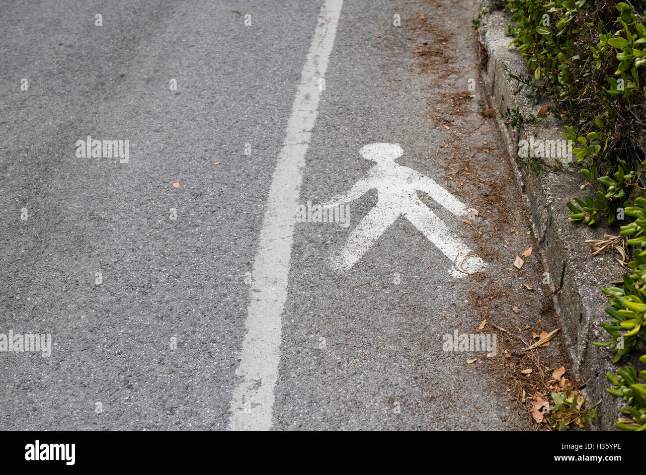 White painted figure on roadside indicating pathway Stock Photo - Alamy