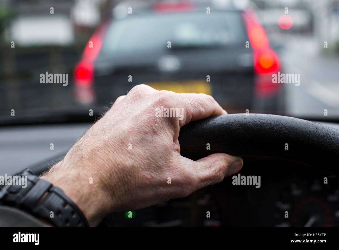 Drivers hand on a car steering wheel Stock Photo - Alamy