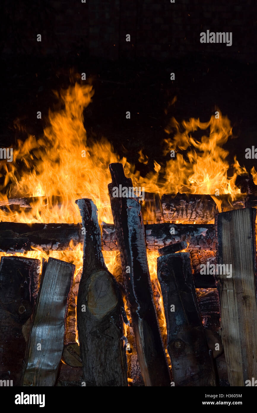 Logs, wood burning on what could be described as a funeral pyre in some ...