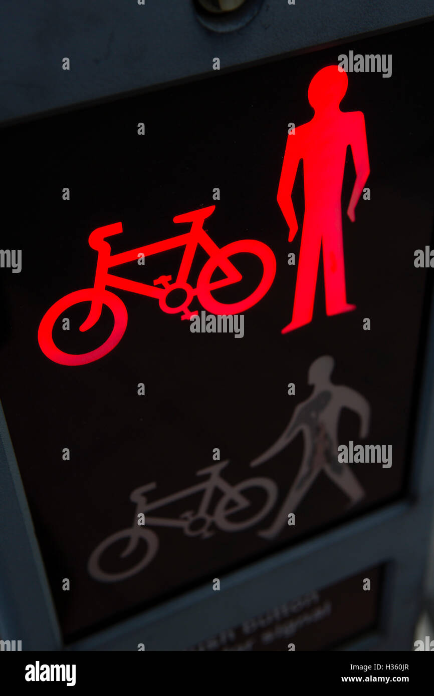 Red crossing lights at a pedestrian crossing for walkers and cyclists ...