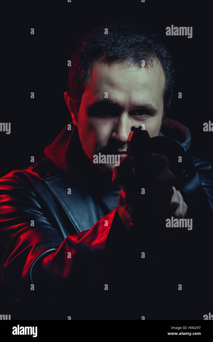 dangerous man with a gun, shooting Stock Photo - Alamy