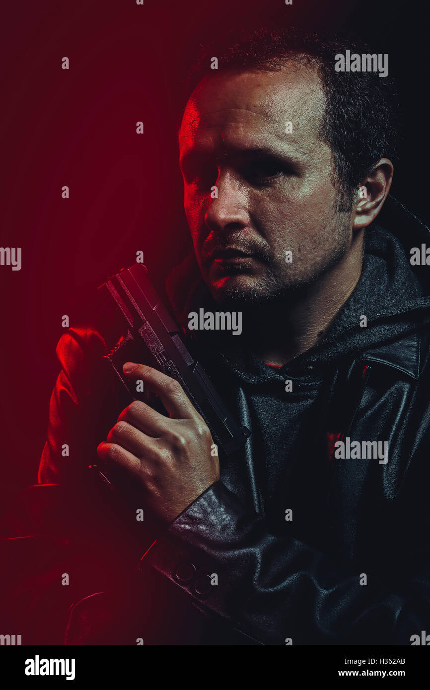Robber with gun over red background Stock Photo - Alamy