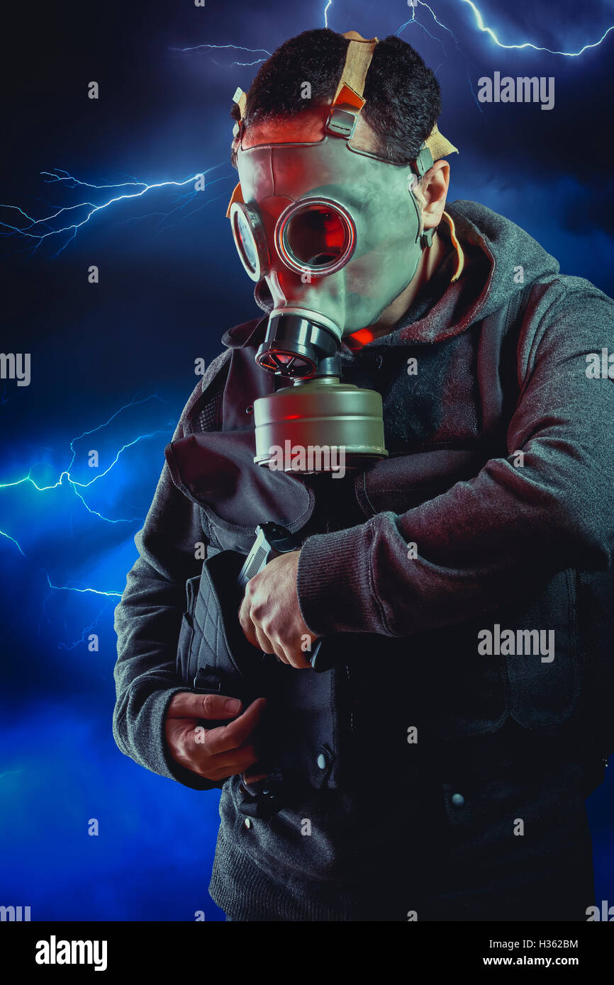 Man with long leather jacket and assault rifle over storm background ...