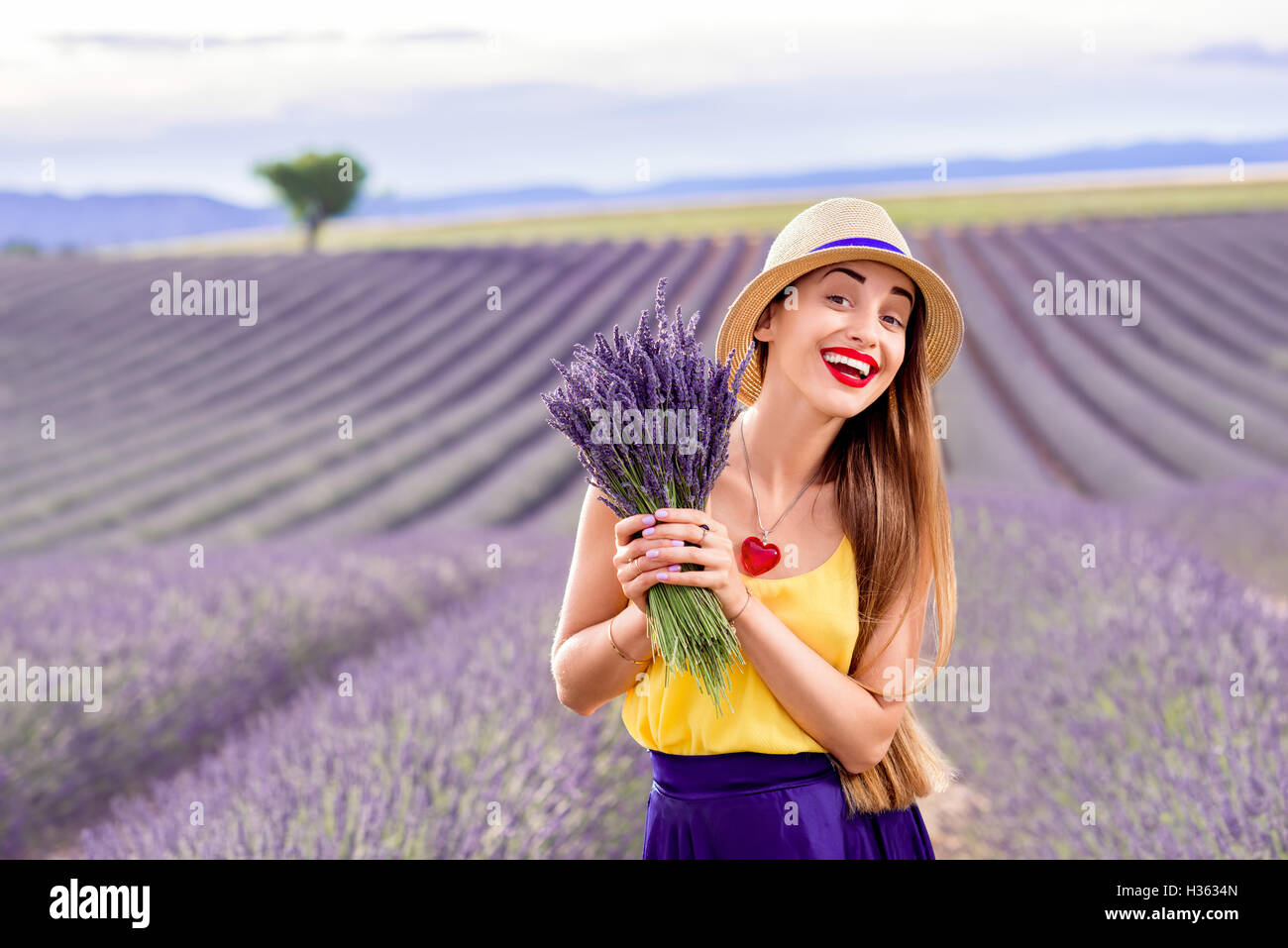 Woman with lavender in the field Stock Photo - Alamy