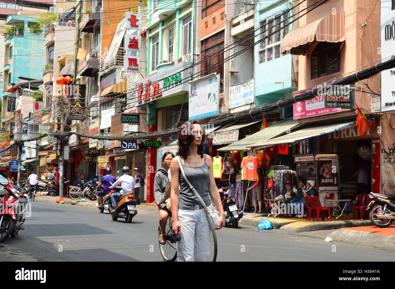 Woman on street of Saigon (Ho Chi Min City) full of wires Stock Photo ...