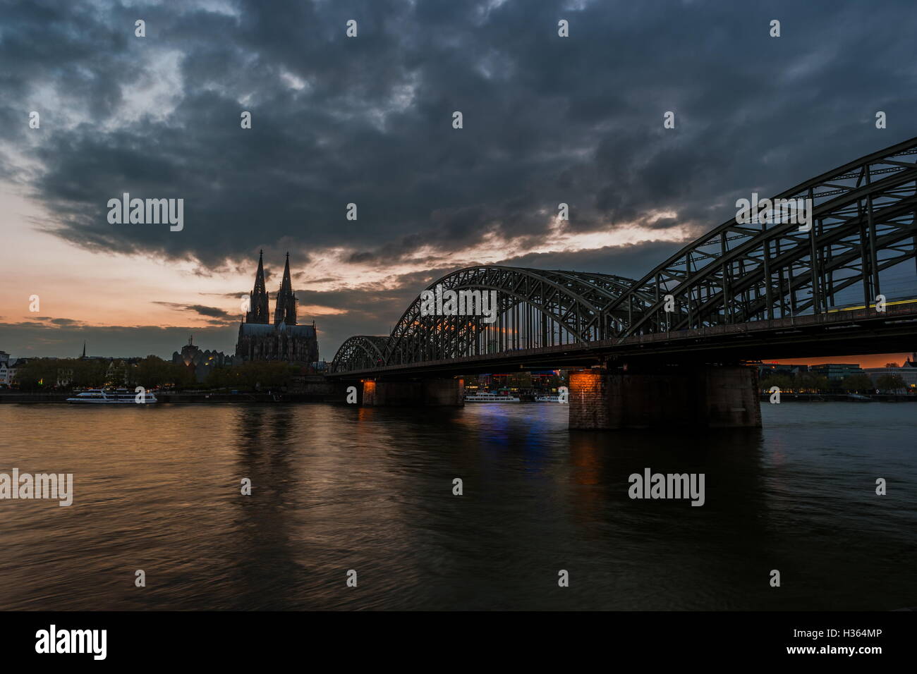 Sunset view of Cologne Cathedral and Hohenzollern Bridge Stock Photo ...
