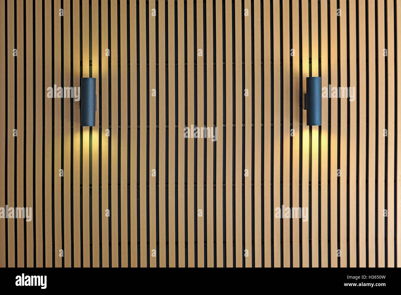 modern wall lamp with light on wooden slat Stock Photo - Alamy
