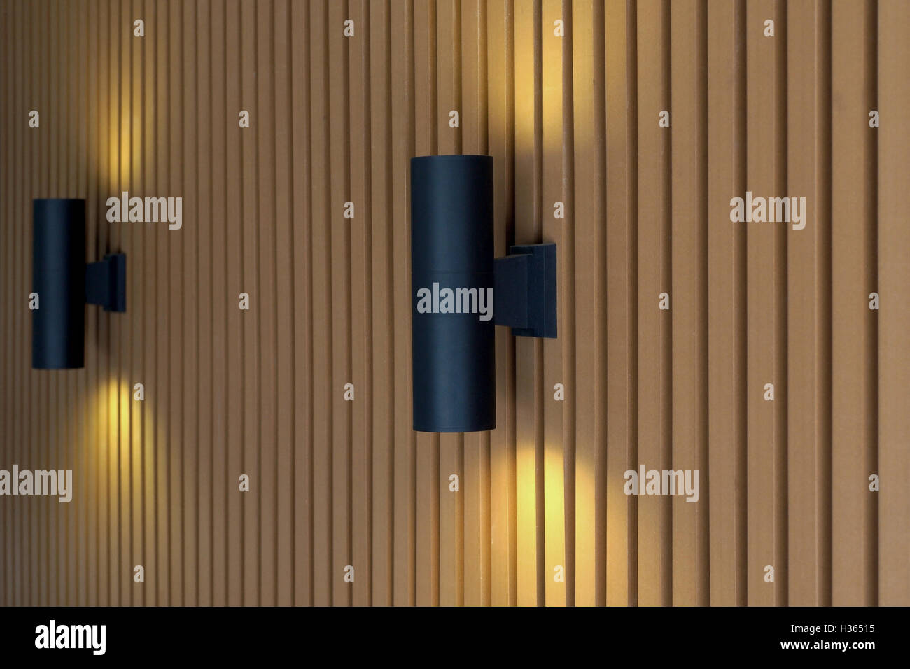 modern wall lamp with light on wooden slat Stock Photo - Alamy