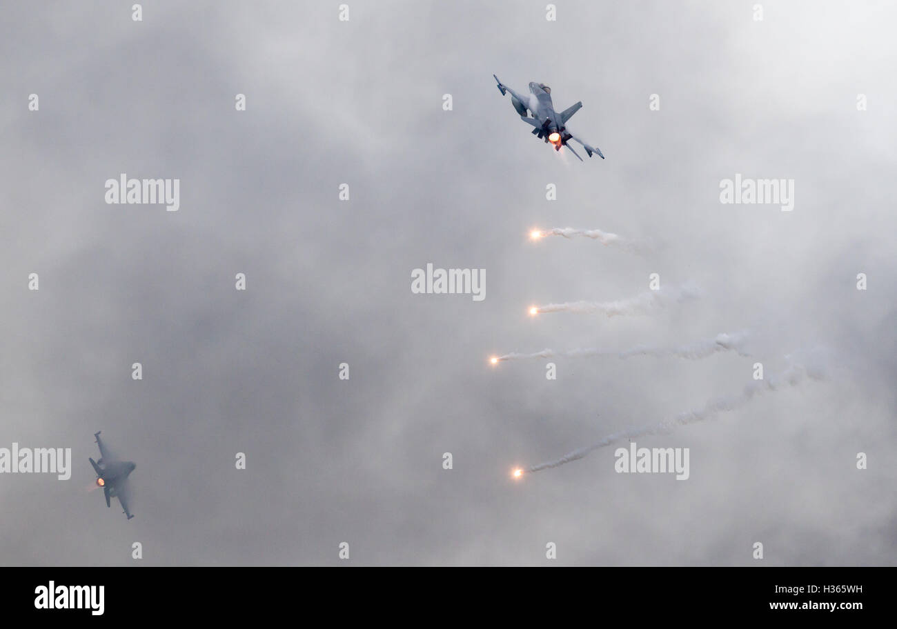 LEEUWARDEN, THE NETHERLANDS - JUN 11, 2016: Dutch F-16 fighter jet firing off flares during a ...