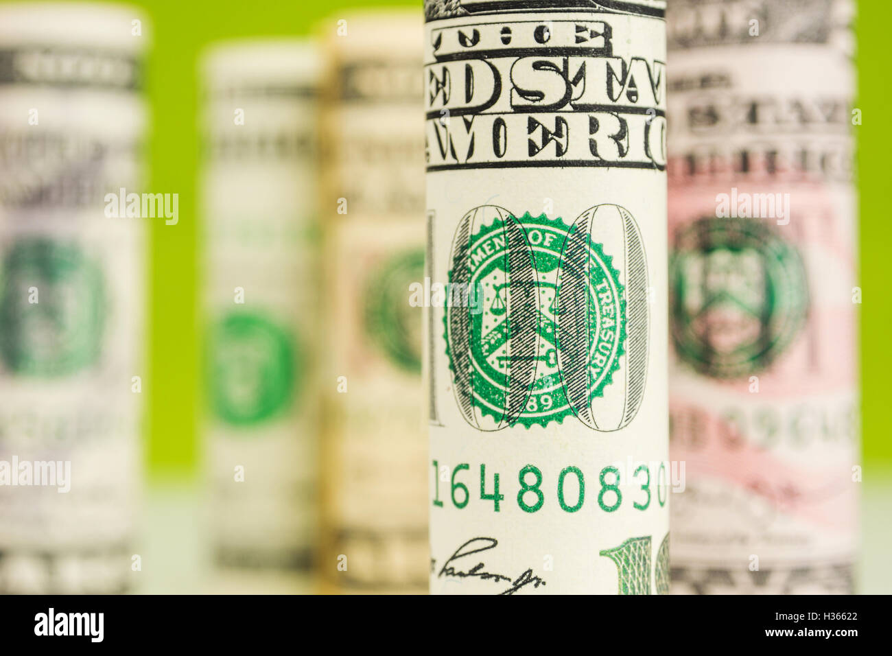 american dollar banknote rolls in all denominations on green background ...