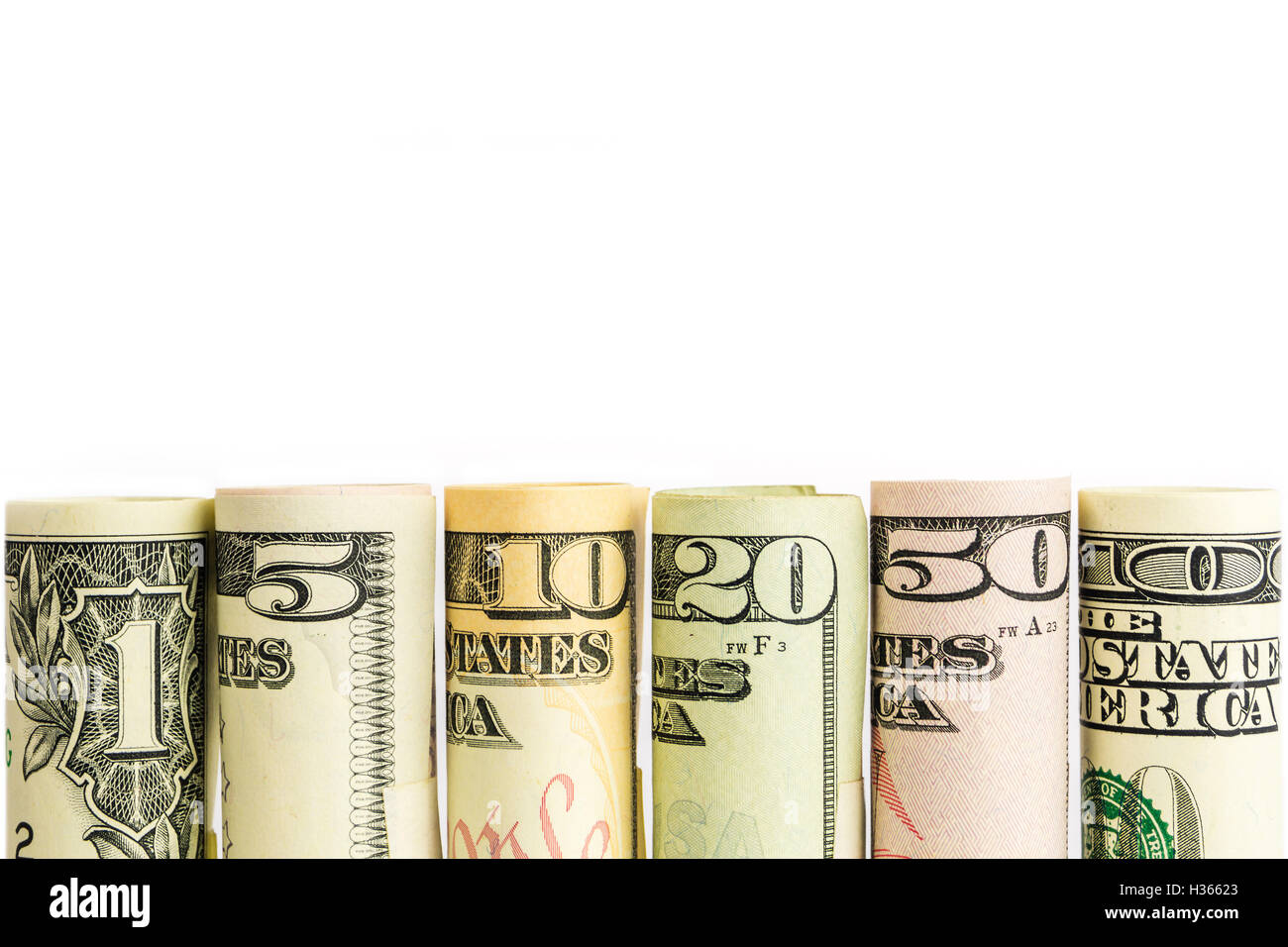 american dollar banknote rolls in all denominations in one row on white ...