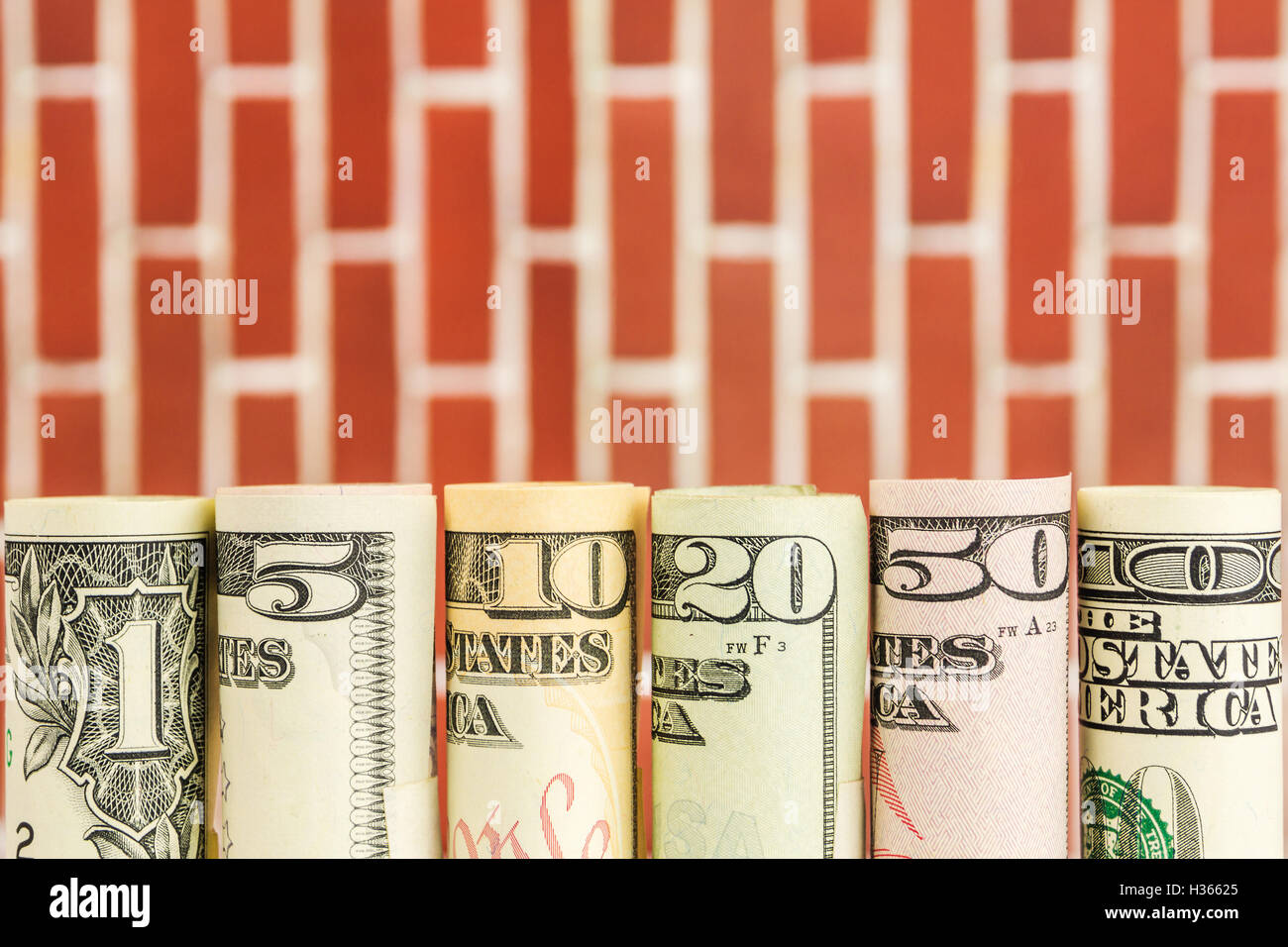 american dollar banknote rolls in all denominations in one row on red ...