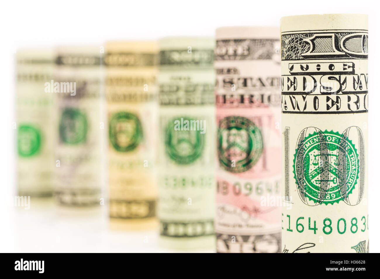american dollar banknote rolls in all denominations in one row on white ...
