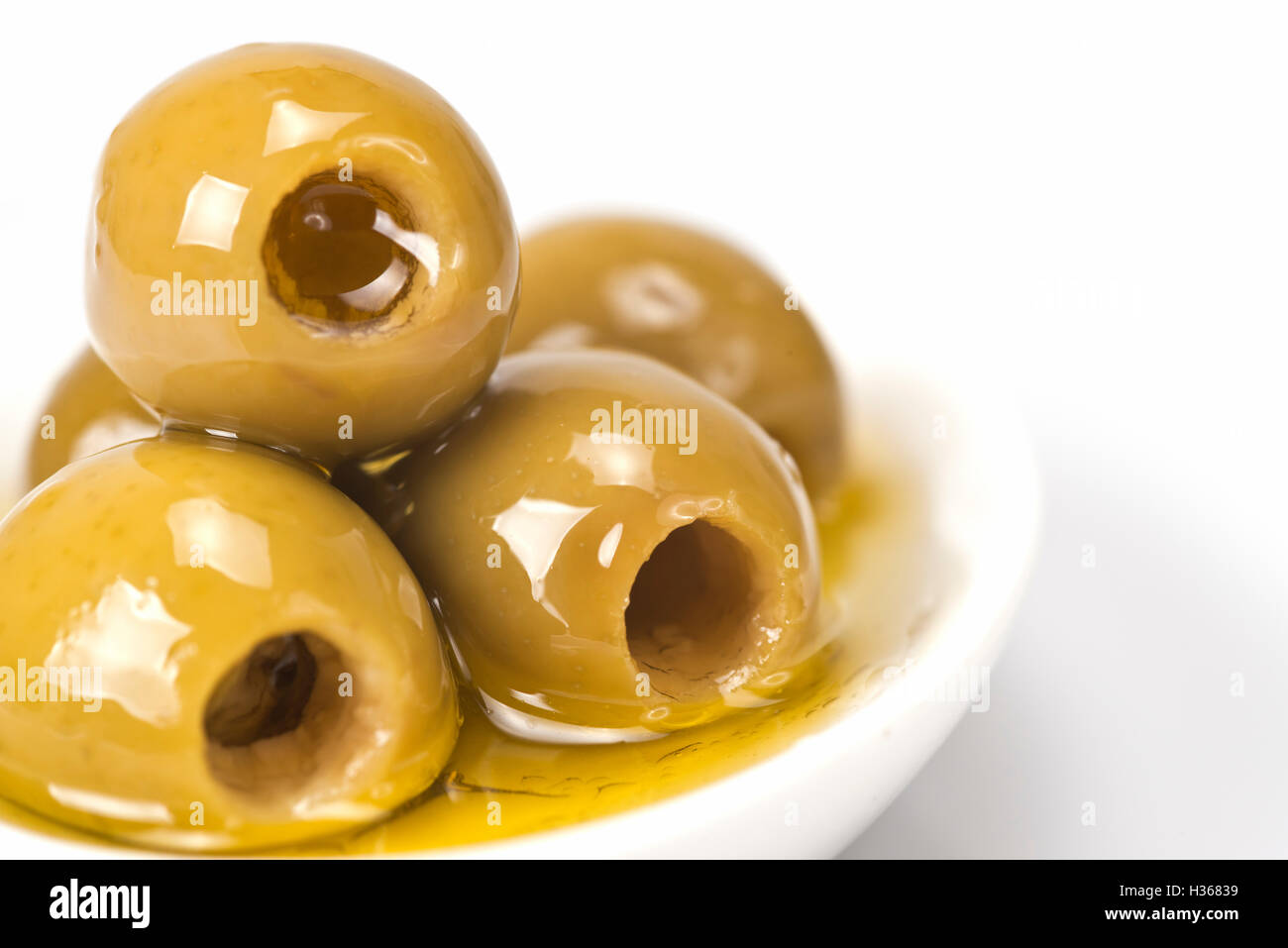 Pitted olives in a saucer isolated on a white background Stock Photo ...