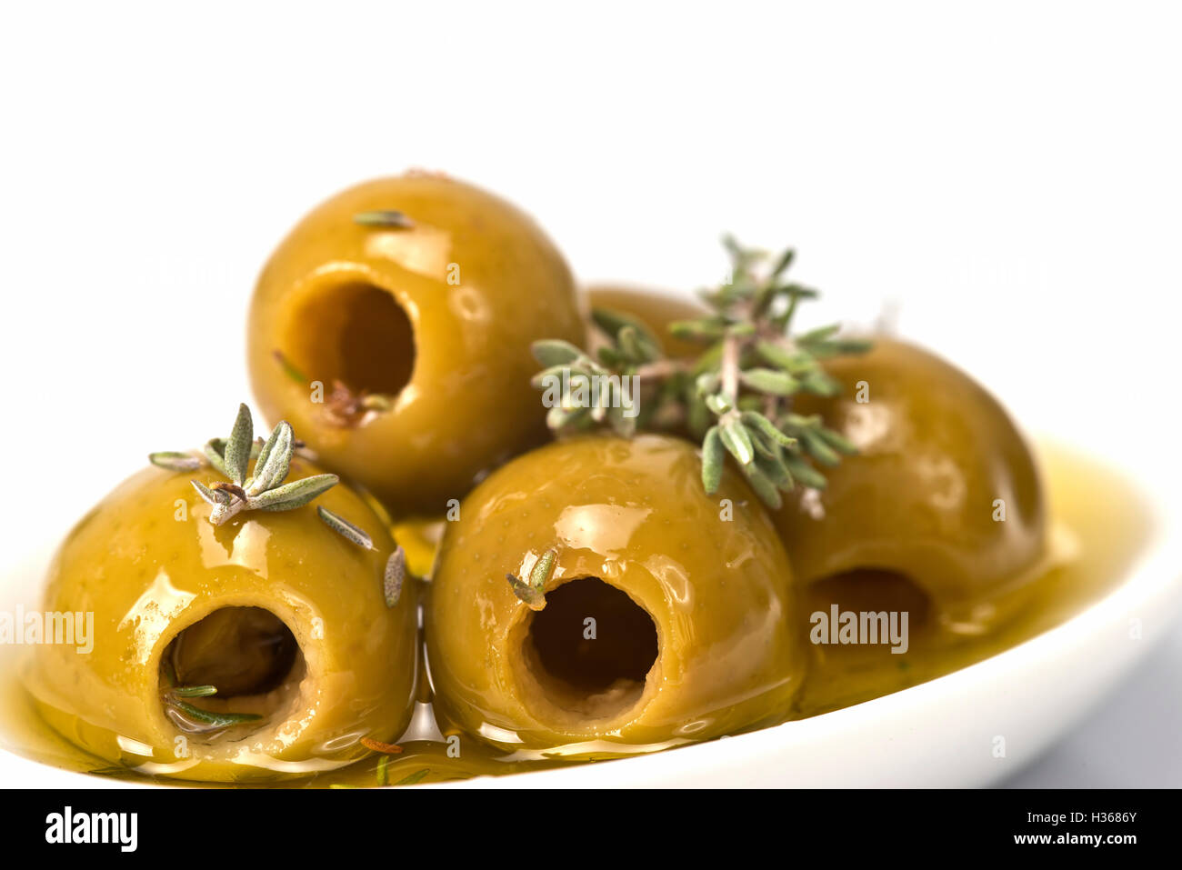 Pitted olives in a saucer isolated on a white background Stock Photo ...