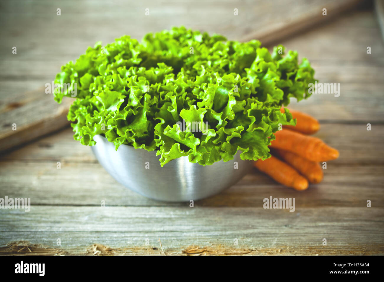 lettuce salad in metal bowl and carrots Stock Photo - Alamy