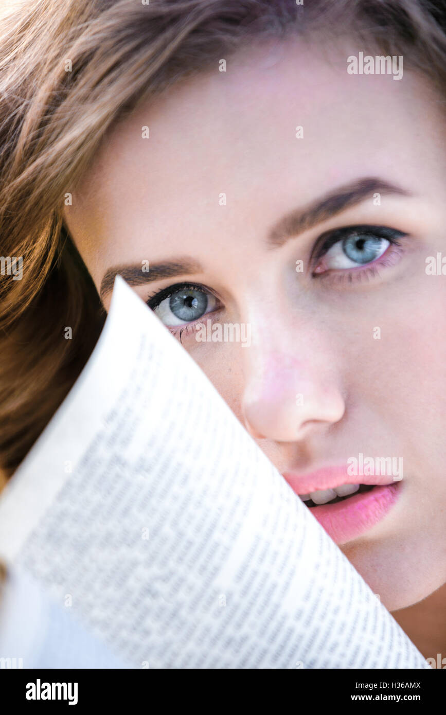 Portrait of a woman reading a book close to face Stock Photo - Alamy