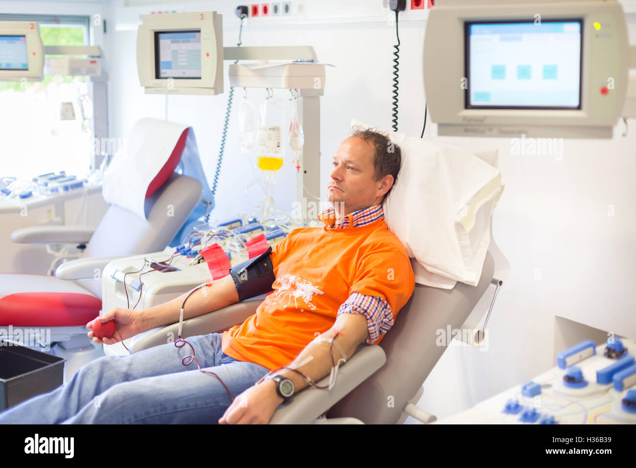 Blood donor at donation Stock Photo - Alamy