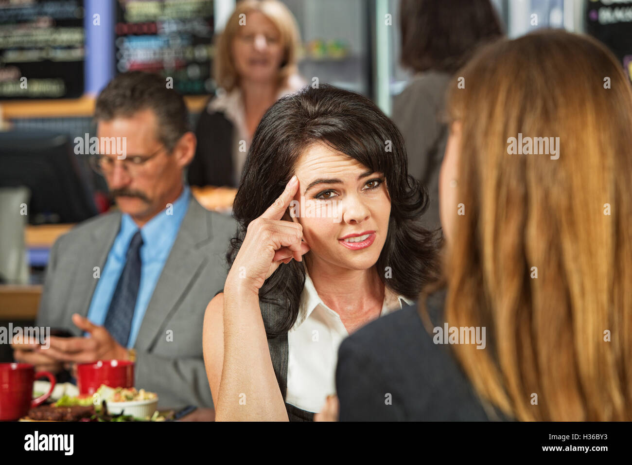 Skeptical Female in Cafe Stock Photo - Alamy