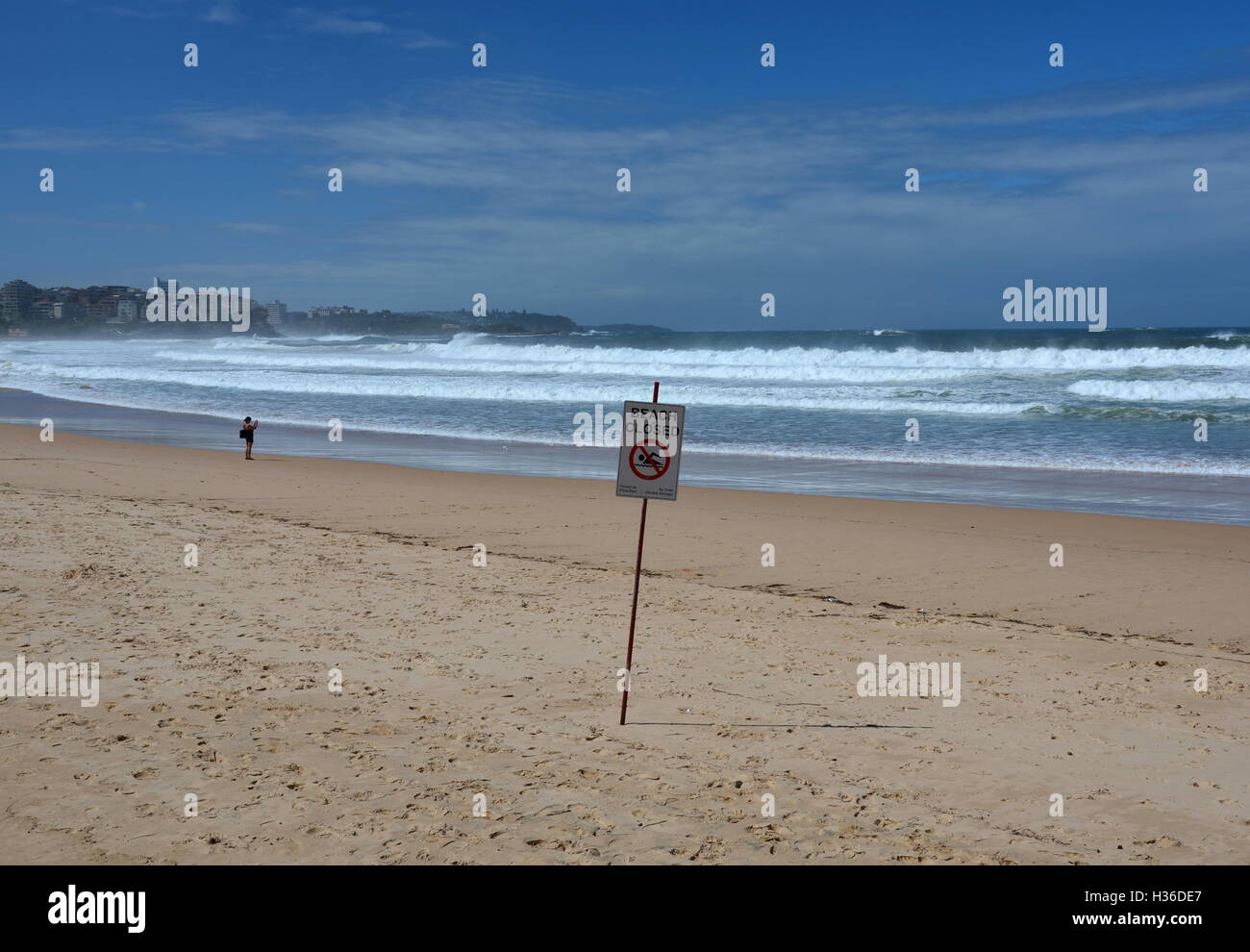 A sign reads beach closed. No swimming flag on the beach before/after ...