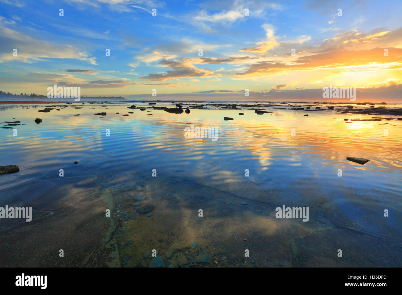 Heaven and Earth reflecting. Morning sky reflected in the ocean Stock ...